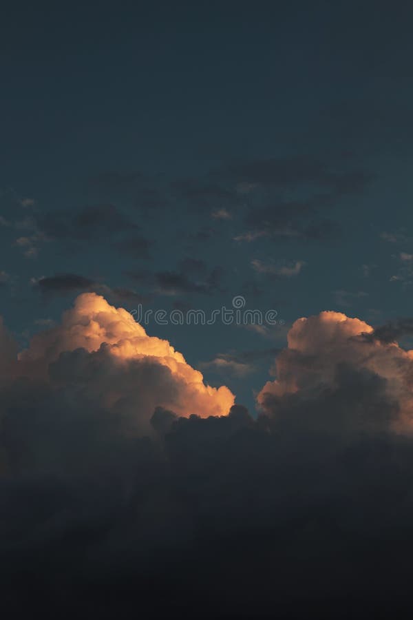 Dramatic Fluffy Backlit Clouds on a Dark Sky, Vertical Stock Photo ...