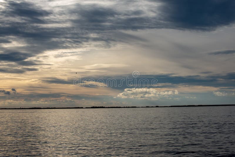 Dramatic High Contrast Clouds in Sunset Over Seaside Beach Stock Image ...