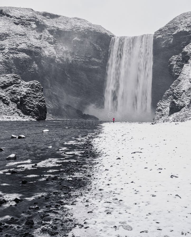 Dramatic Iceland Waterfall with Person Standing in Front of it Stock ...