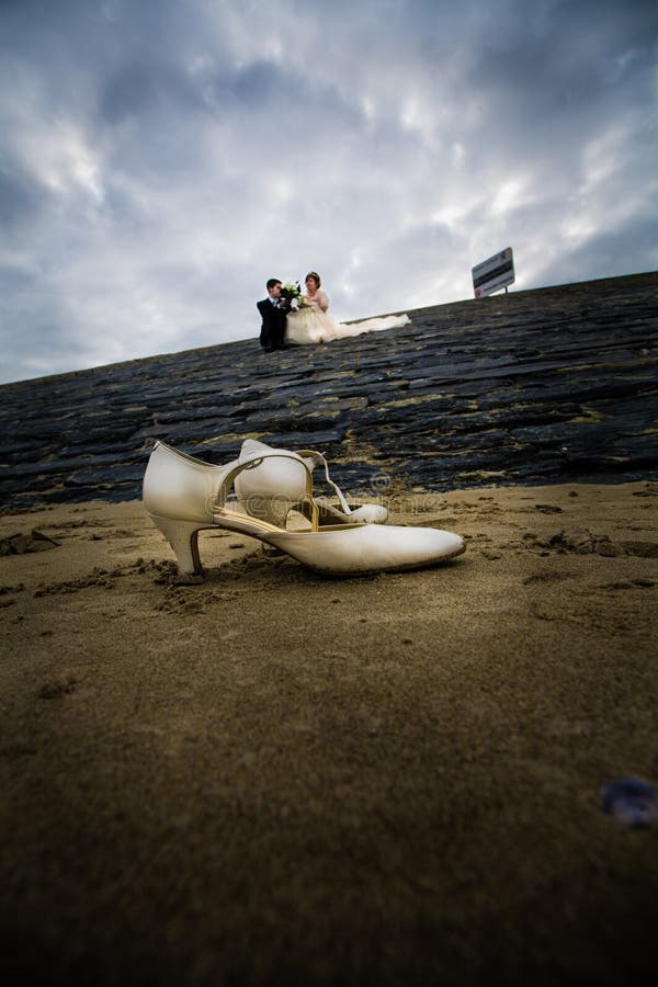 Beachfront Nuptials: Bridal Shoes and Seaside Vows Stock Photo - Image ...
