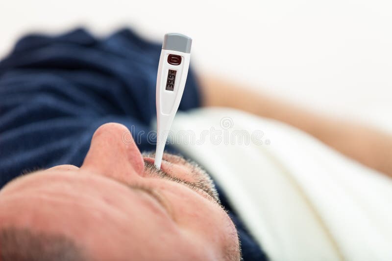Dramatic Image of a Sick Man Laying in Bed with Fever Stock Photo ...