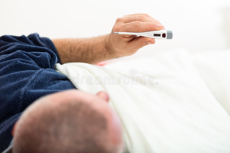 Dramatic Image Of A Sick Man Laying In Bed With Fever Stock Photo ...