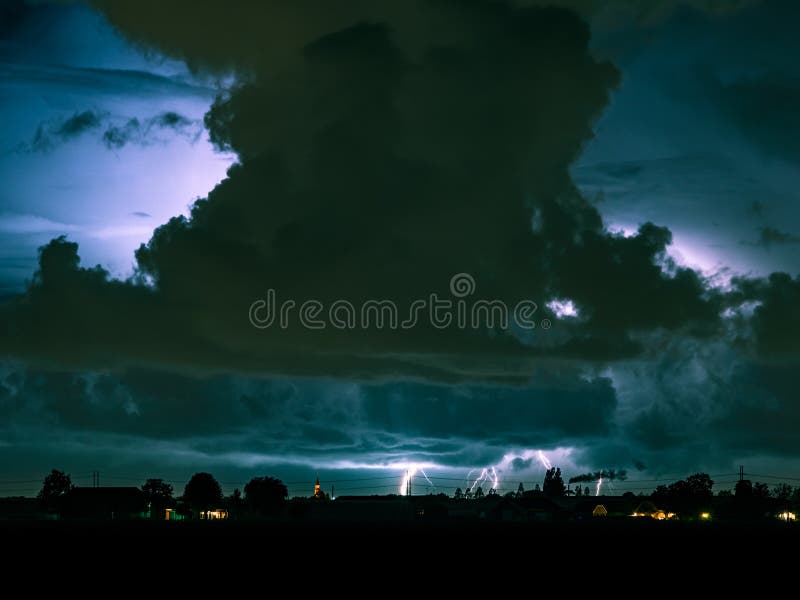 Lightning Strikes Down from a Distant Thundercloud Stock Image - Image ...