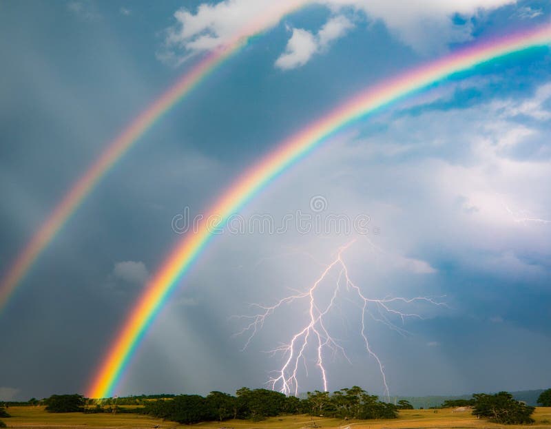 Dramatic Lightning Strike in Stormy Sky with Rainbow Stock Photo ...