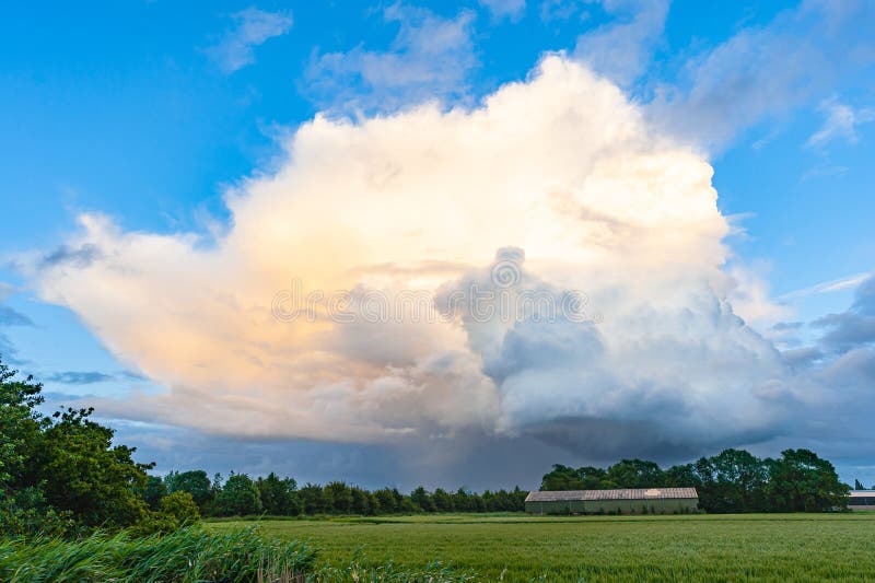 Dramatic Looking Storm Cloud is Colorfully Illuminated by the Setting ...