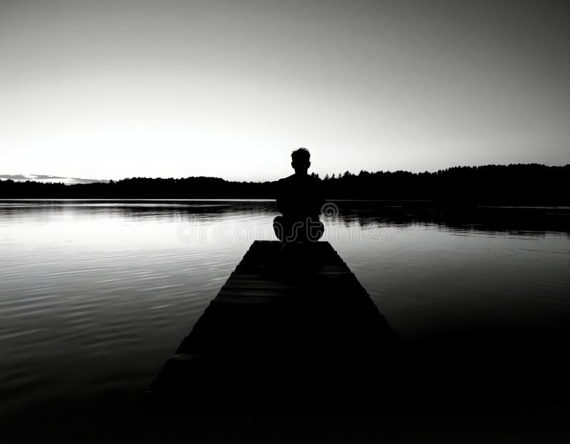 Dramatic Monochrome Solitude: Man Meditating on Dock at Gloaming Stock ...
