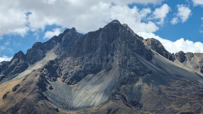 A Dramatic Mountain Range with Sharp Peaks and Ridges Under a Partly ...