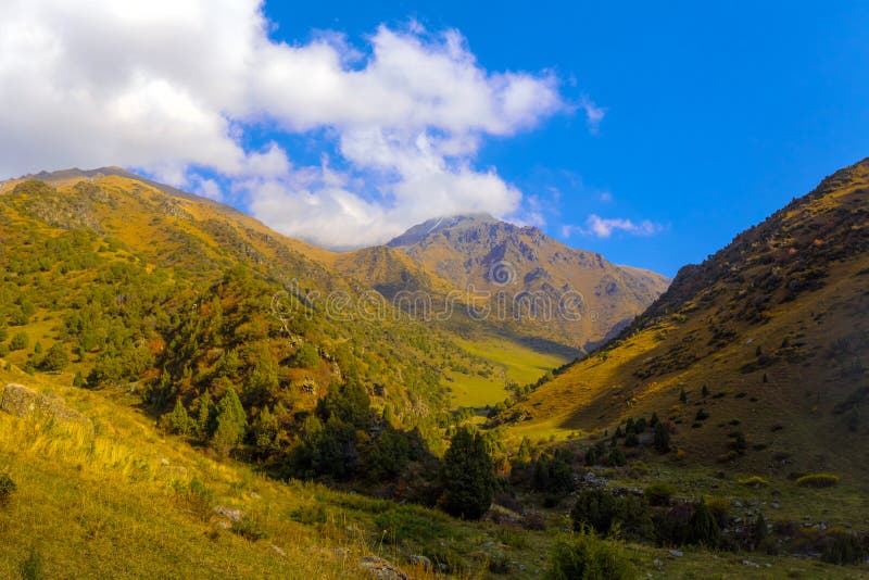 Dramatic Mountain Valley with Steep Slopes, Patches of Vegetation, and ...