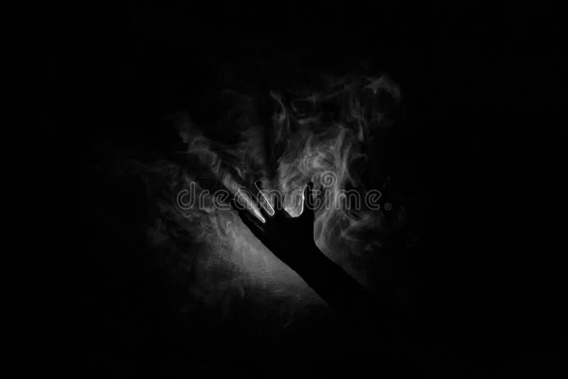 Dramatic Mysterious Dark Shot of a Backlit Hand Surrounded by Smoke ...