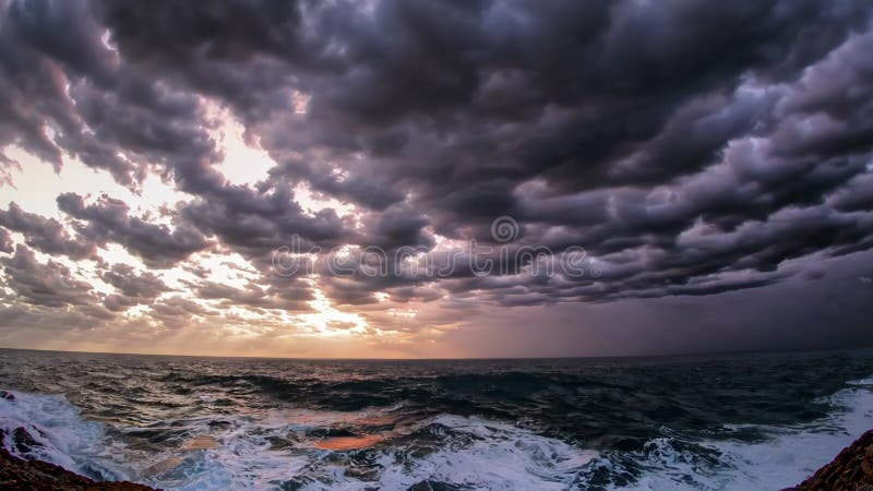 Dramatic Ocean Sunset with Purple Clouds and Waves Crashing on Rocks ...