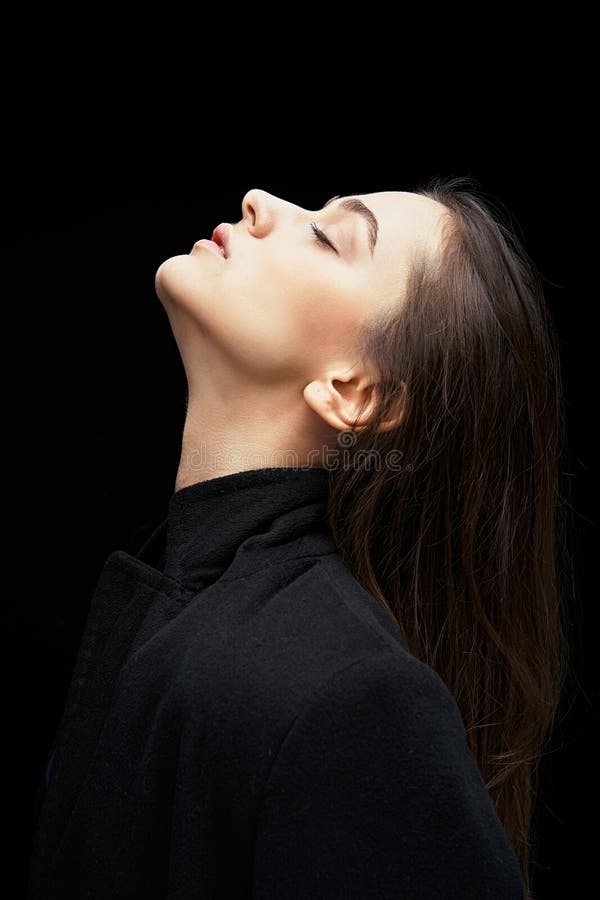 Dramatic Portrait Of A Beautiful Lonely Girl Isolated On A Dark