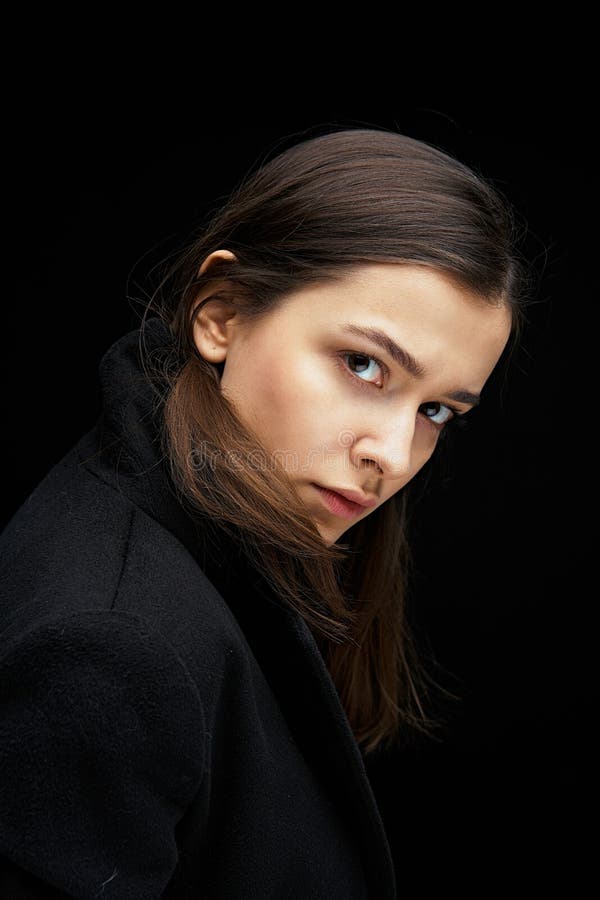 Dramatic Portrait Of A Beautiful Lonely Girl Isolated On A Dark