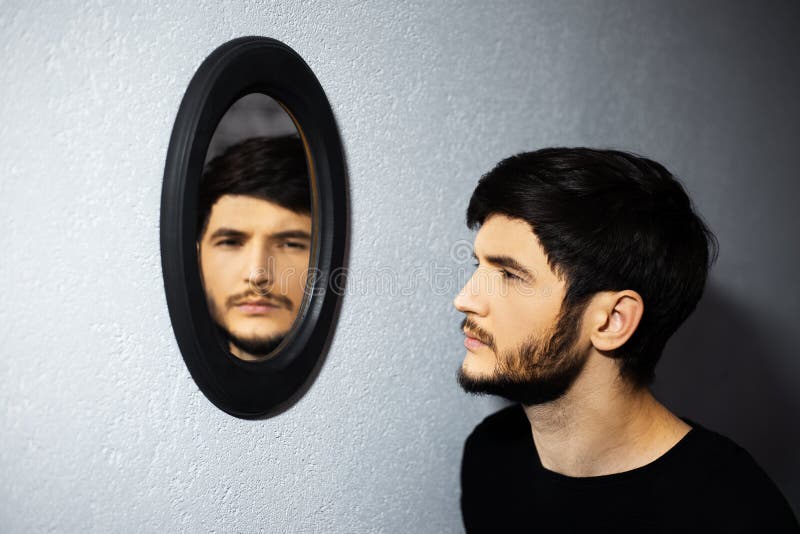 Dramatic Portrait of Young Thoughtful Guy, Looking at His Reflection in ...