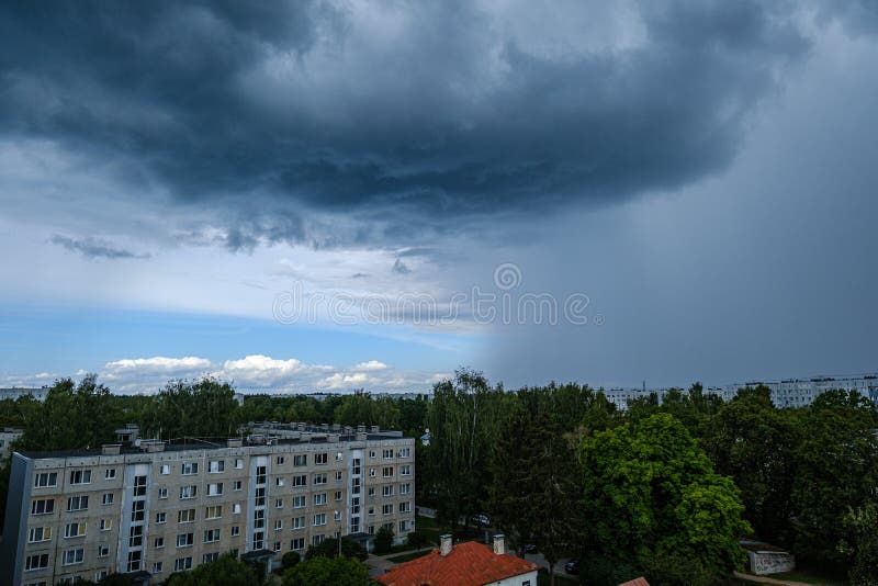 Dramatic Rain Clouds Over City Rooftops Stock Photo - Image of dawn ...