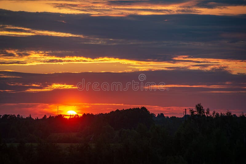 Dramatic Red Sunset Colors in the Sky Above Trees and Fields Stock ...