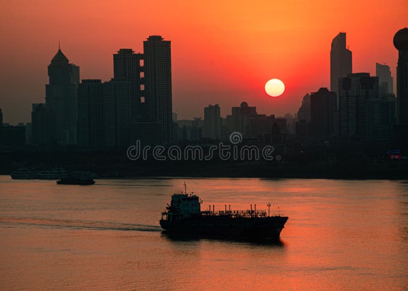 Dramatic Red Sunset Over the Silhouette of a City at the Waterfront ...