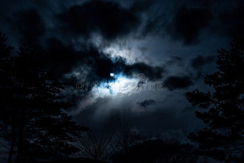 Dramatic Scene of the Moon Hidden Behind the Dark Clouds in the Night ...