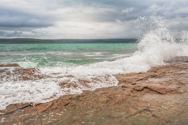 Dramatic Scene with Sea Waves, Rocky Seashore and Clouds Stock Photo ...