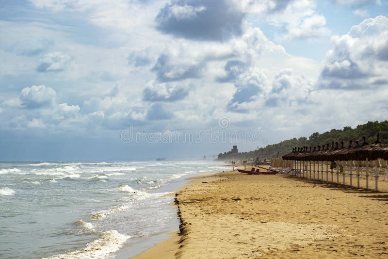 Dramatic Scene of Seascape Beach with Waves, Sand, Parasol and Cloudy ...