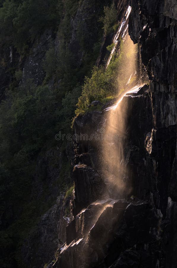 Dramatic Scene of Sunlight Illuminating a Gentle Waterfall Cascading ...