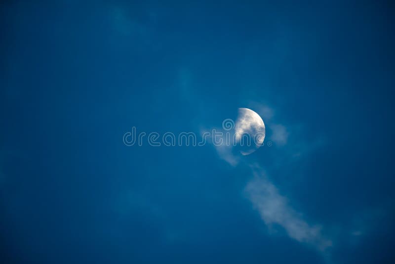 Dramatic Scenery of the Moon Behind the Clouds in the Blue Sky at Nigh ...