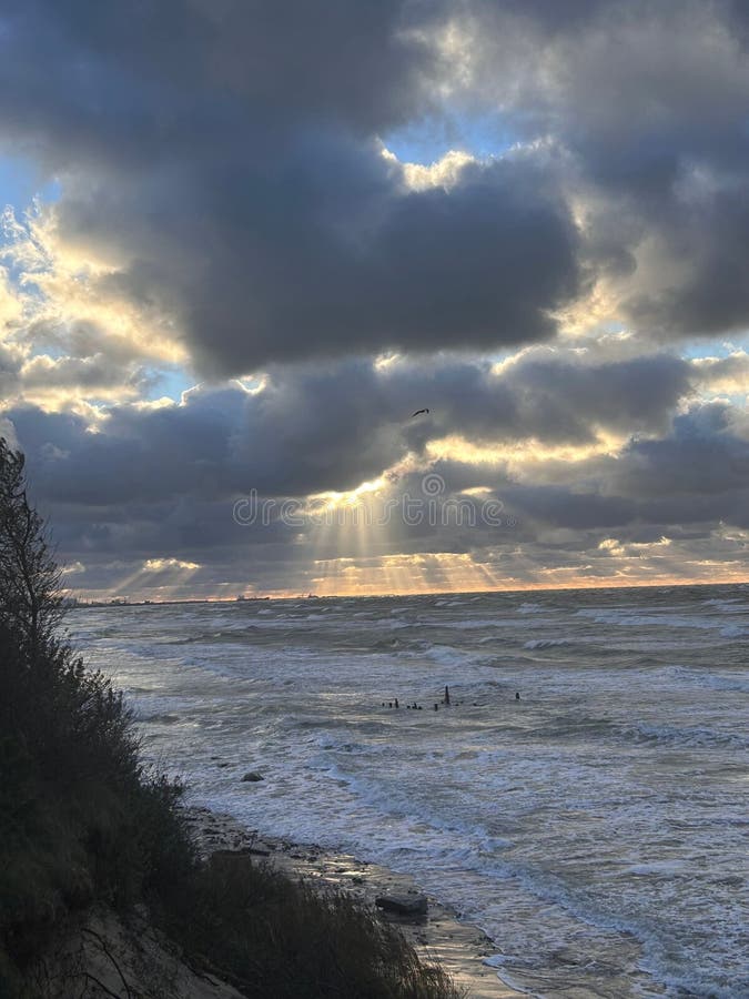 Dramatic Seascape with Sun Rays Breaking through Clouds Over the Stormy ...