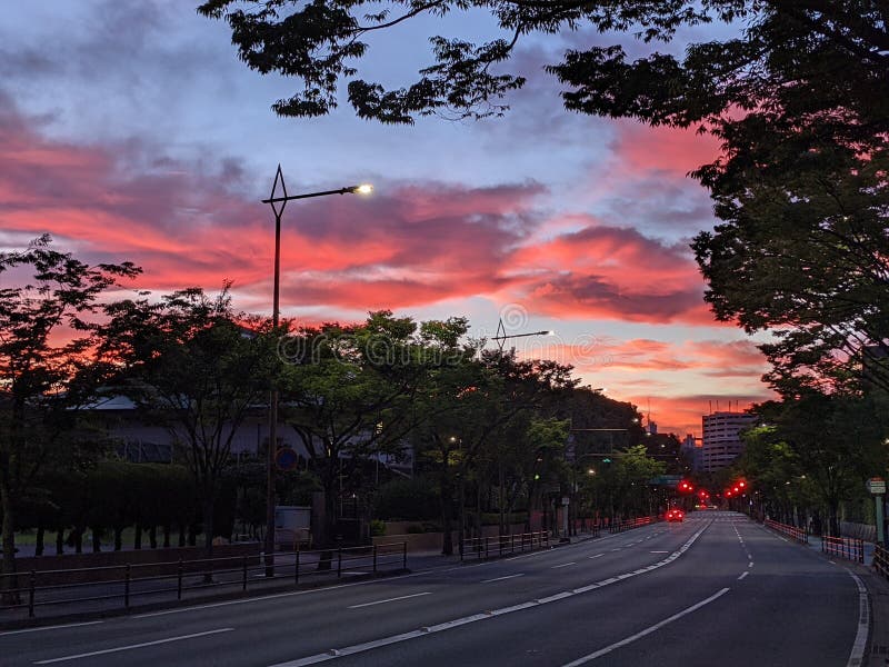 Dramatic Sky Over a Main Road with Pinkish Cloud Formations at Dawn ...