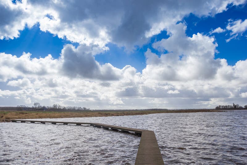 Dramatic Sky Over the Wooden Walking Path in Roegwold Stock Photo ...
