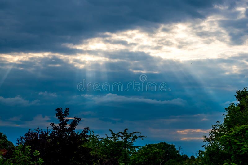 Dramatic Sky with Sun Rays at Sunset, Green Trees Stock Photo - Image ...