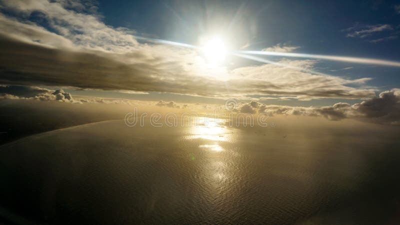 Dramatic Sun Filled Skyline with Ocean Below Stock Image - Image of ...
