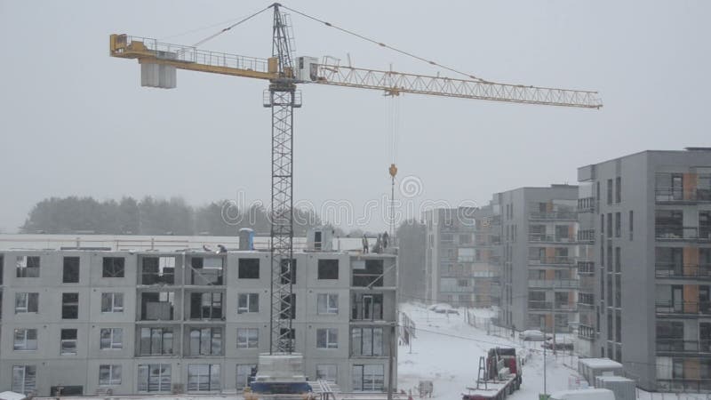 Snow Fall and Construction Site Workers Build House in Winter Stock ...