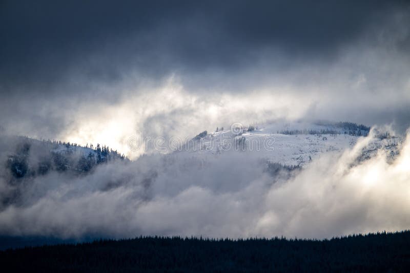 Dramatic Snowy Mountain Landscape with Dark Clouds. Stock Image - Image ...