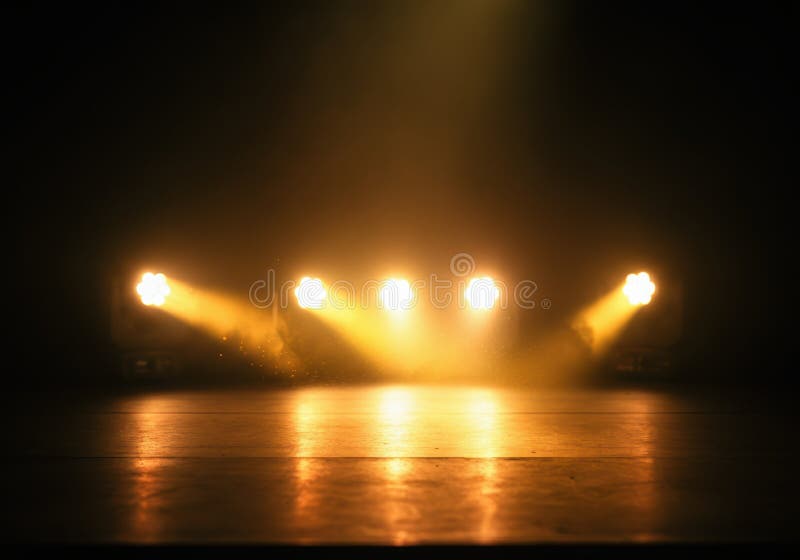 Dramatic Stage Lights Illuminating a Performance Area with a Warm Glow ...