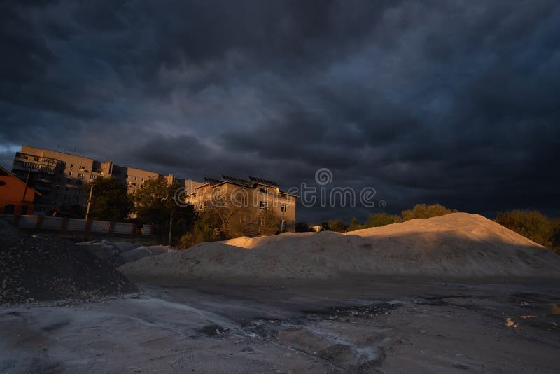 Dramatic Storm Clouds Over the Rooftops at Summer Sunset Stock Image ...