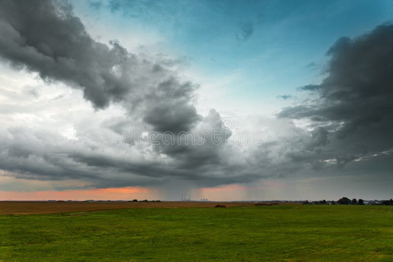 Dramatic Stormy Clouds and Sky Over Green Fields and Power Plant Stock ...