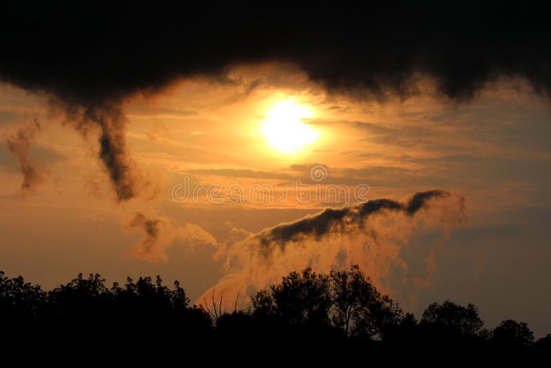 Dramatic Stormy Clouds Surrounding Sun at Sunset Over Local Forest ...
