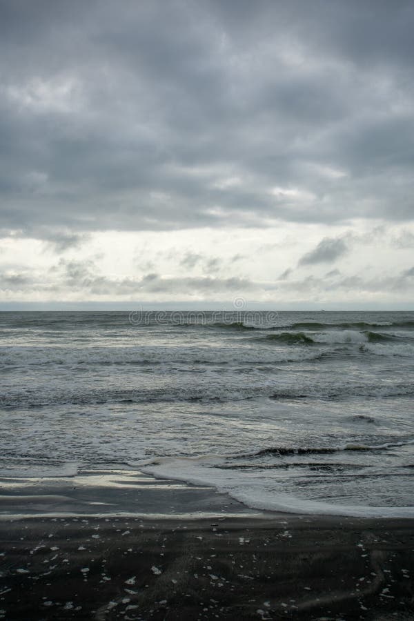 A Dramatic Stormy Sky Over a Dark Beach Stock Photo - Image of ...