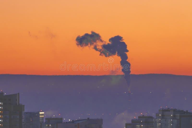 Dramatic and Stunning Sunset with Smoke Streaking Across the Cityscape ...
