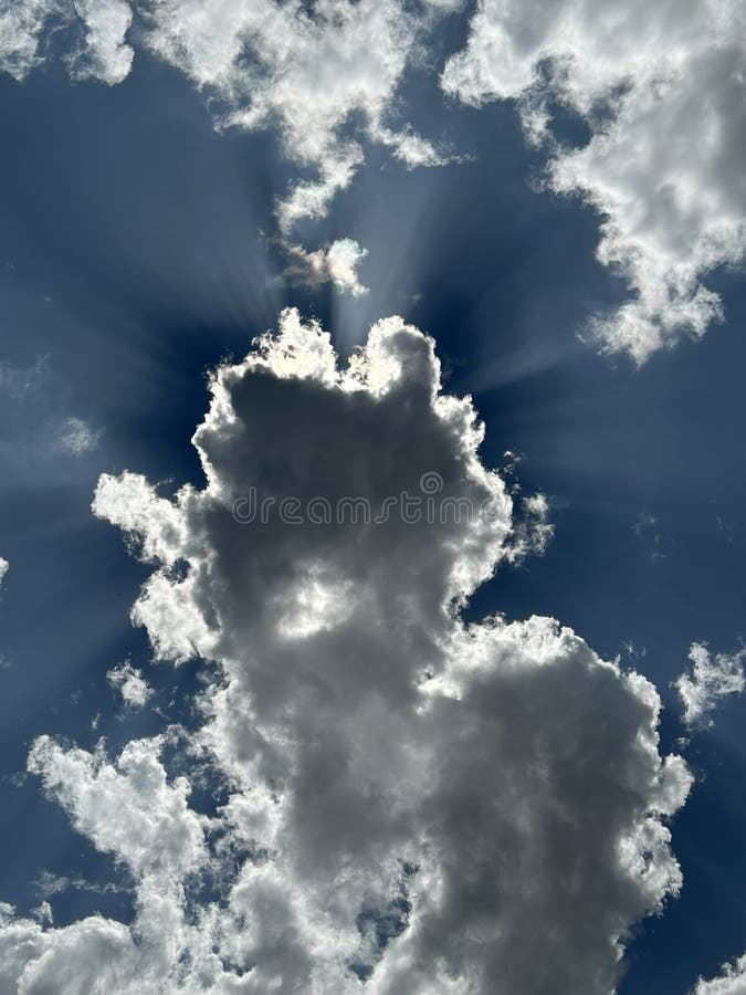 Dramatic Sun Rays Burst through Fluffy Clouds in Blue Sky Stock Image ...