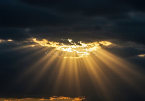 Dramatic Sun Rays Penetrating Dark Clouds in a Stunning Sky View Stock ...
