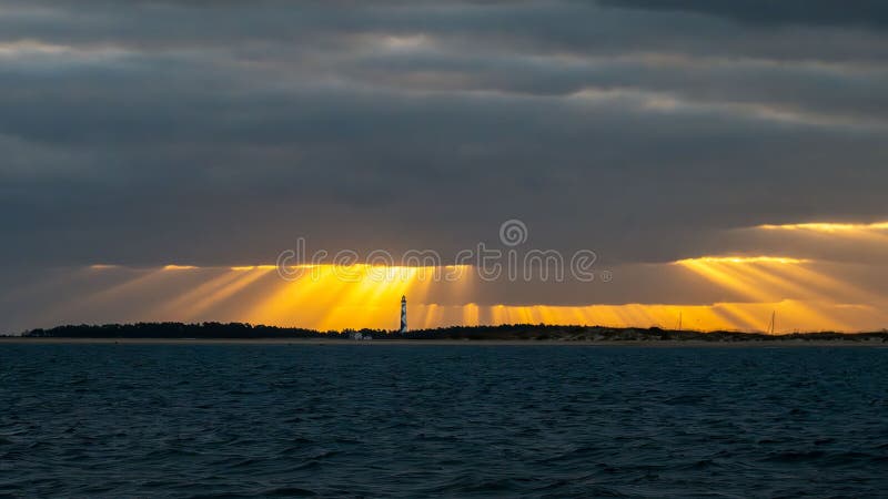 Sun Rays Over Lighthouse and Sea Stock Image - Image of sunset ...
