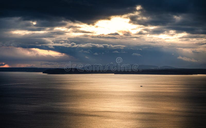 Dramatic Sunlight through Cloudy Sky Over Sea Surface, Seattle, USA ...