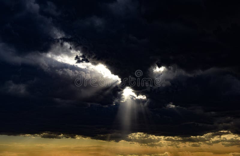 Dramatic Sunrays Punch through Rain Clouds. Stock Image - Image of ...
