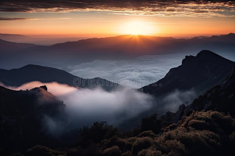 Dramatic Sunrise Over Mountain Range, with Clouds and Mist in the Air ...