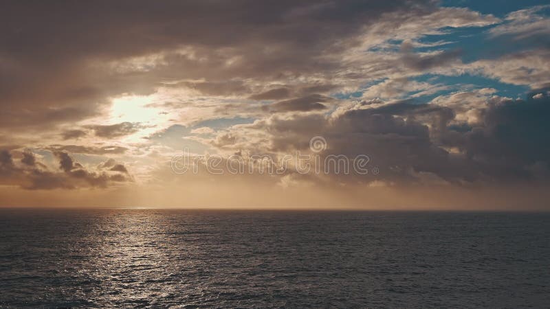 Dramatic Sunrise Over the Ocean. a Ray of the Sun Breaks through the ...