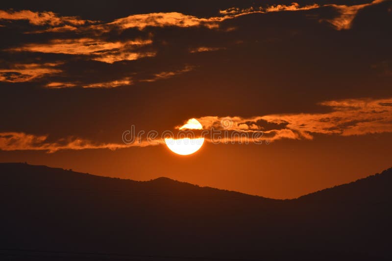 Dramatic Sunset Against a Backdrop of Rugged Mountain Peaks. Stock ...