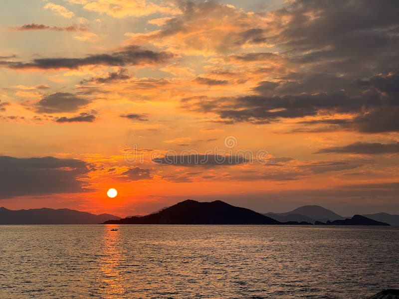 Dramatic Sunset Against the Sea. Sunlight Reflection Stock Photo ...