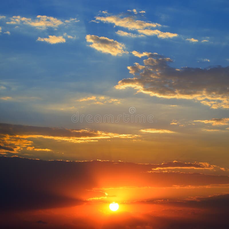 Dramatic Sunset Background with Bright Sun, Blue Sky and Clouds Stock ...