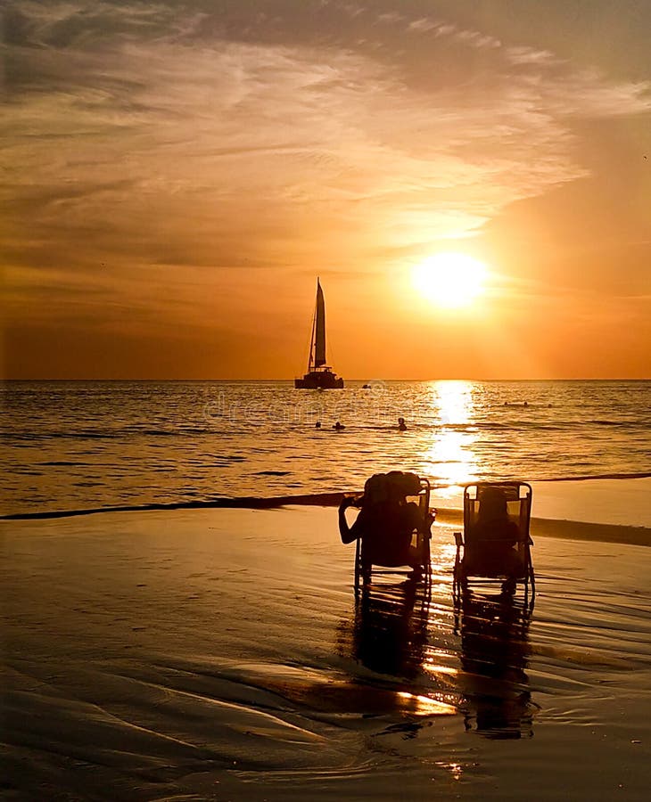 The Shadow Couple, the Boat and the Dramatic Sunset Stock Photo - Image ...