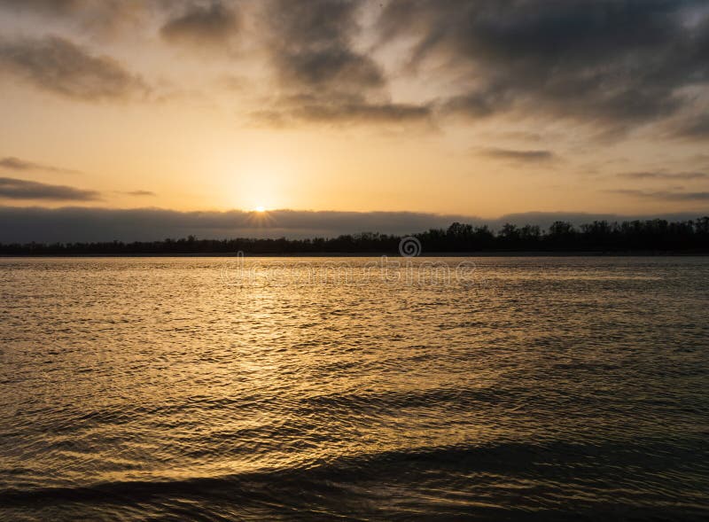 Dramatic Sunset on a Cloudy Sky on a Wide Lake Stock Photo - Image of ...